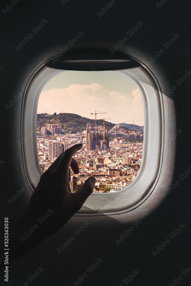Airplane window with a aerial panorama of Barcelona, Spain with Sagrada ...