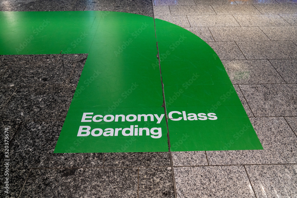 Economy class boarding green painted lane at airport boarding area in ...