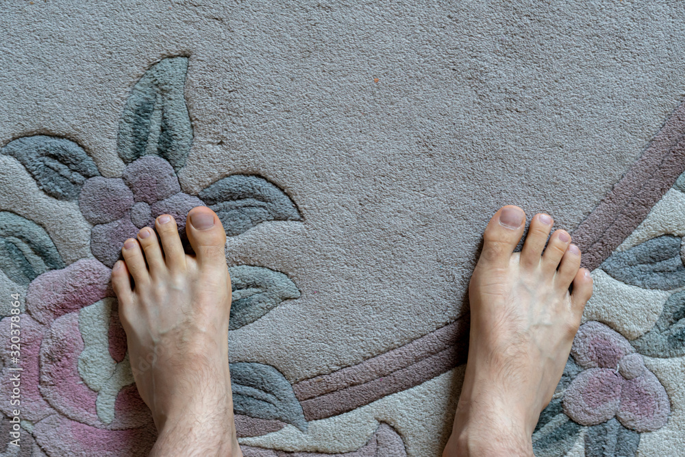 the bare feet at home on the carpet on the floor, wake up early in the ...