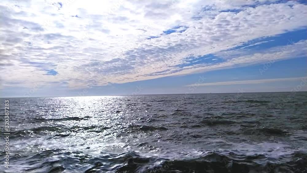 Sea waves crashing slow motion. Beautiful blue and white clody sky ...