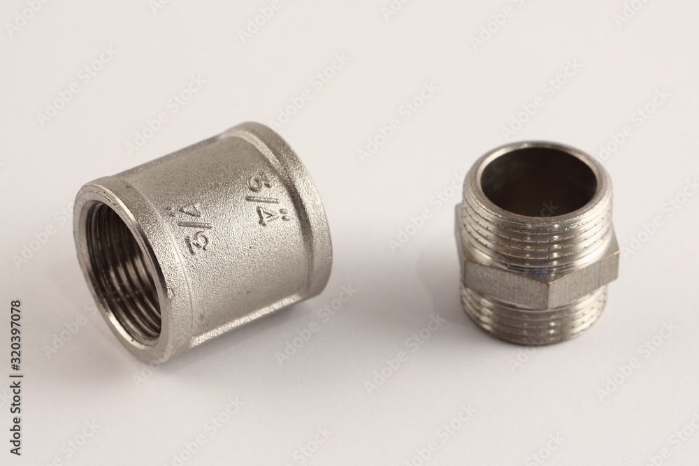 3/4" thread coupling sleeve and G 3/4" threaded pipe connectors, close ...