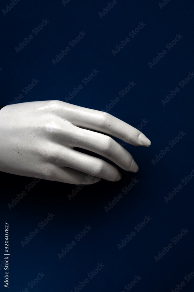 Mannequin hand on a blue background. Art model for drawing. Part of the ...