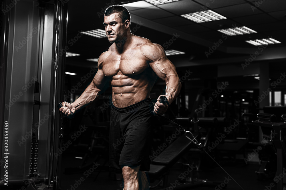 Muscular man bodybuilder training in gym and posing. Fit muscle guy ...