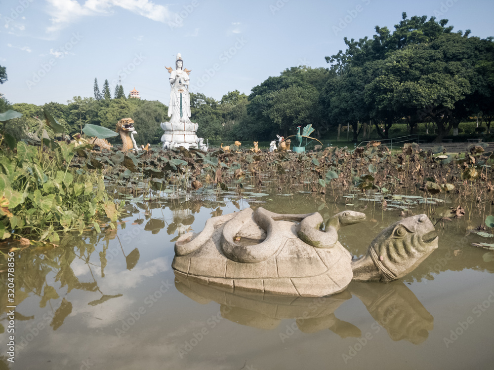 turtle & snake statue in louts filled lake with chinese goddess statue ...