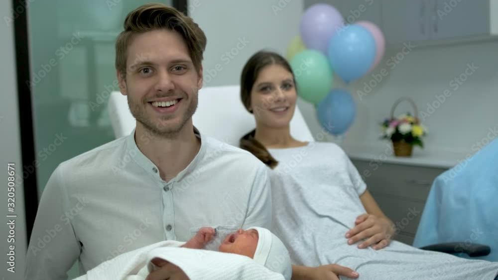 Portrait of happy family man father holding new born child after birth ...