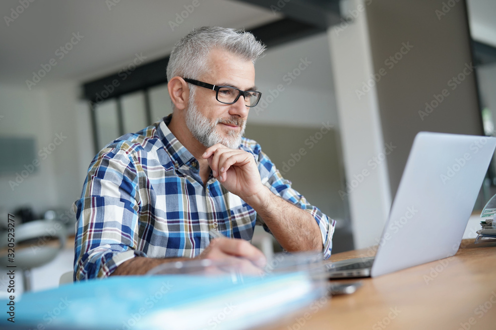Man working from home on laptop computer Stock Photo | Adobe Stock