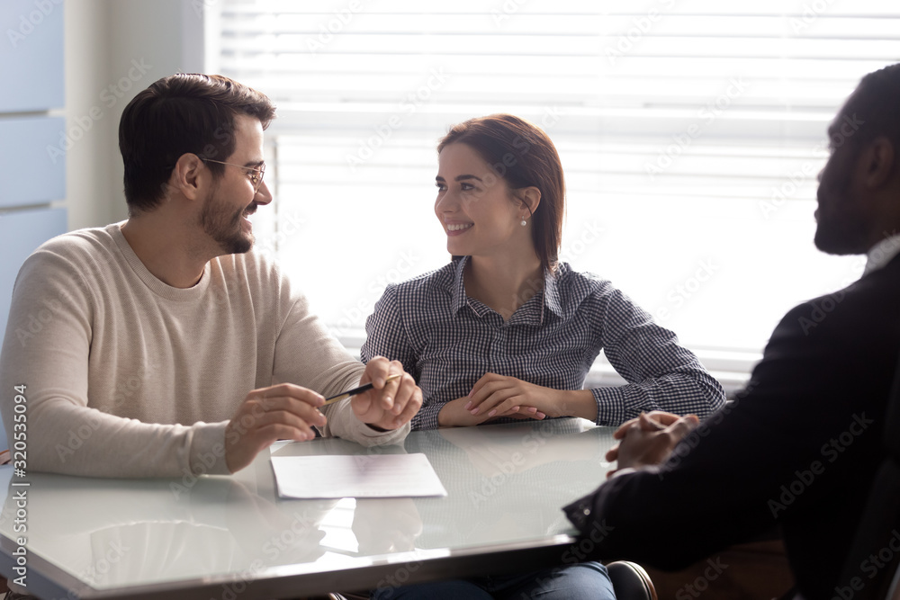 Couple and insurance agent during meeting ready to sign agreement Stock ...