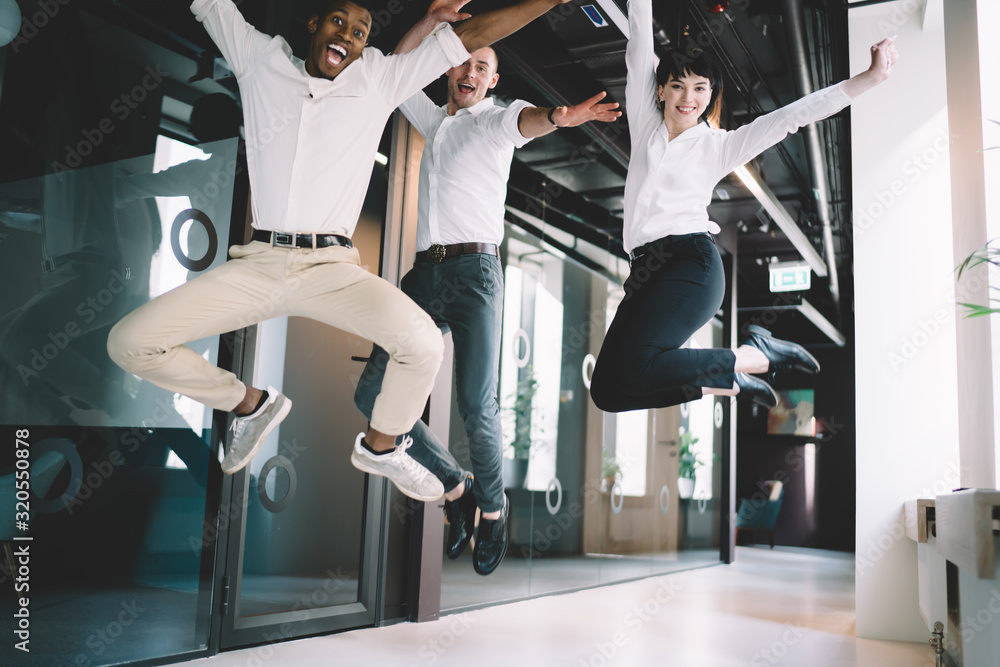 Business team celebrating success by jumping together in office Stock ...