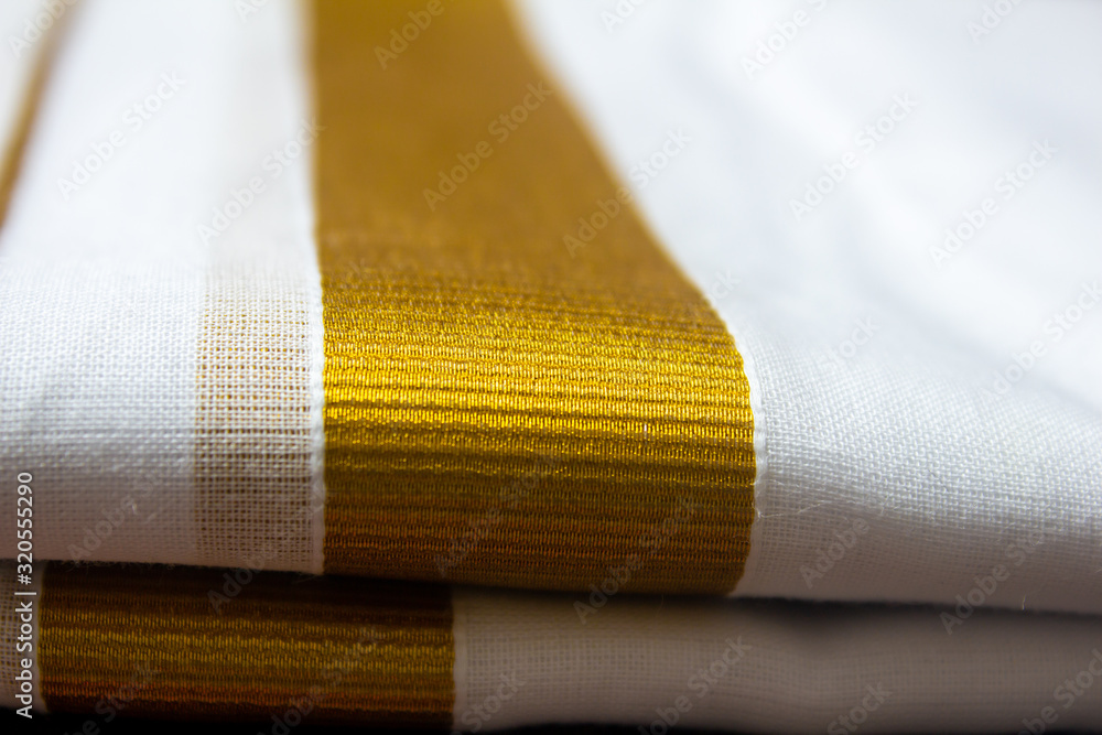 Close view of the dhoti with gold threaded border. Dhoti is a ...