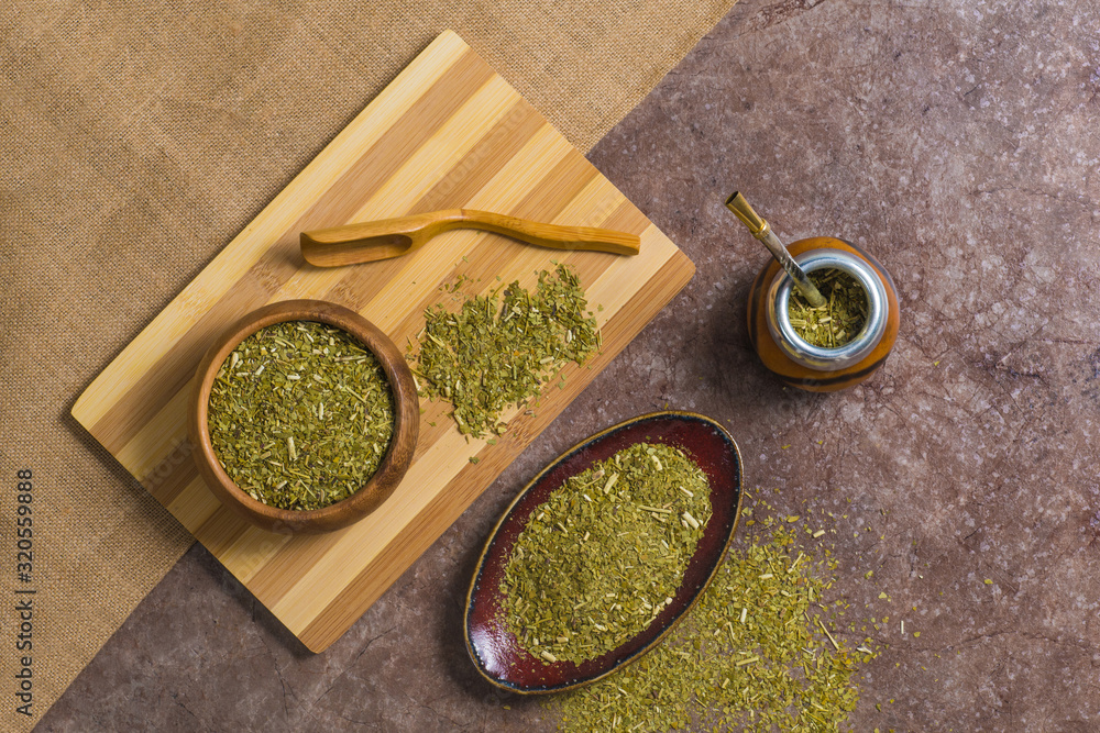 Flat lay yerba mate tea in calabash and in bowls with bamboo desk Stock ...