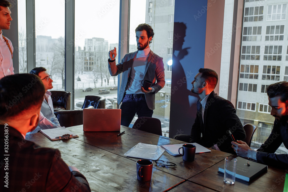 business crew coworking in modern office with neon lights. handsome ...