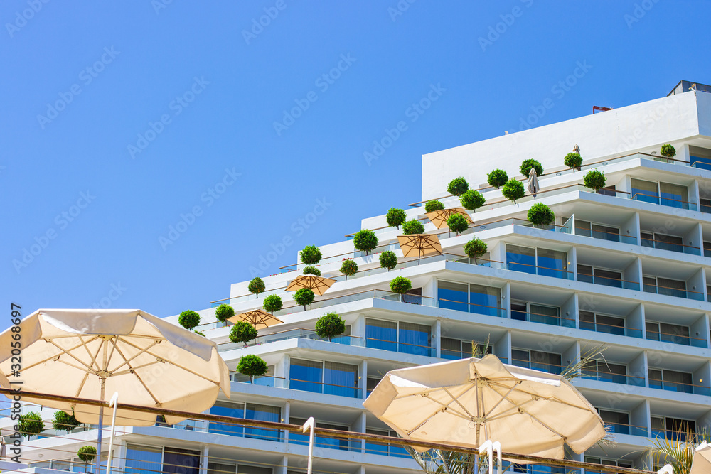 resort hotel terrace exterior building with umbrella in yard sunny day ...