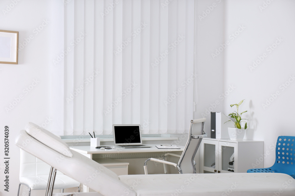 Doctor's office interior with desk and examination couch Stock Photo ...