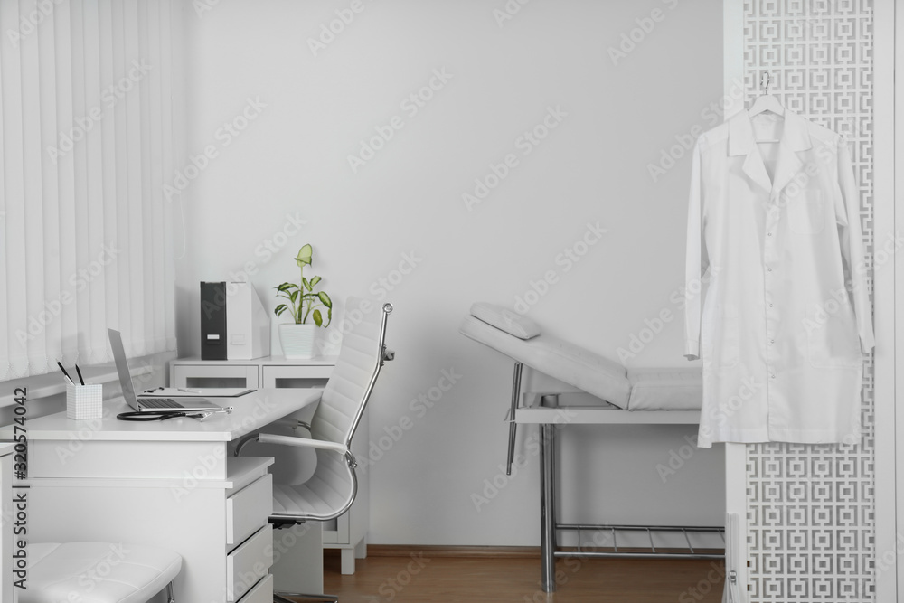 Doctor's office interior with desk and examination couch Stock Photo ...