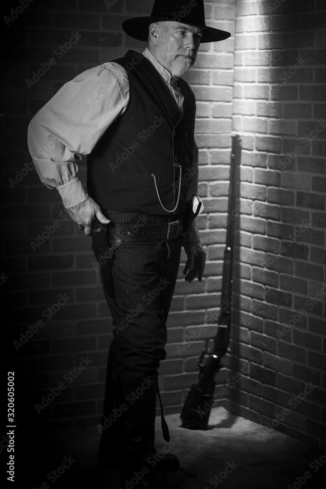 1885 wide shot old west cowboy ready to draw his pistol wide shot Stock ...