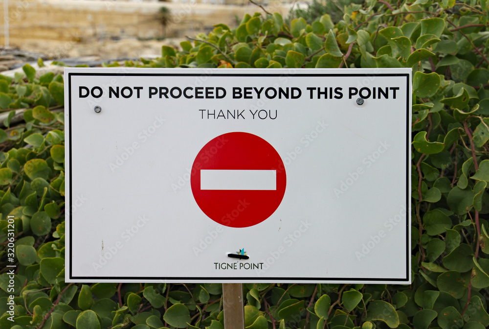 Sign with a red circle with a white bar warning not to proceed beyond ...