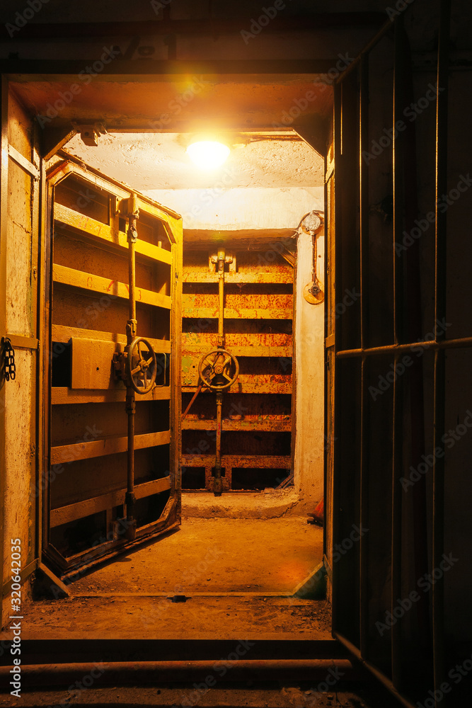 Old rusty hermetic metal armored door with valve, entrance of abandoned ...