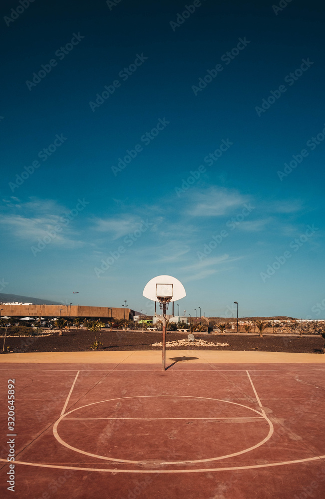 red basketball court and a big blue sky Stock Photo | Adobe Stock