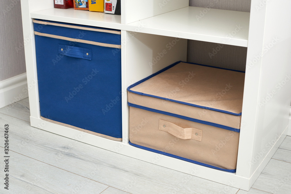 The drawer is divided into cells of different sizes, for separate ...