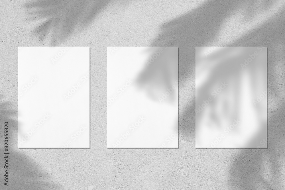 Three empty white vertical rectangle poster or business card mockups ...