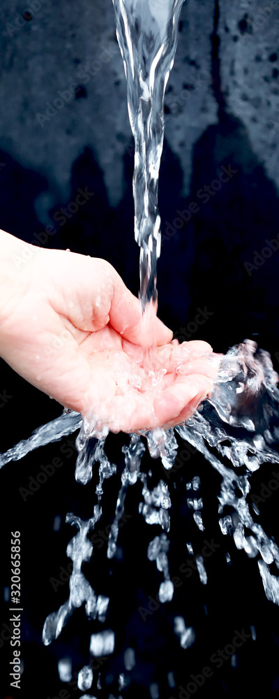 Selective focus. Female hand under a stream of clear water. Splashing ...