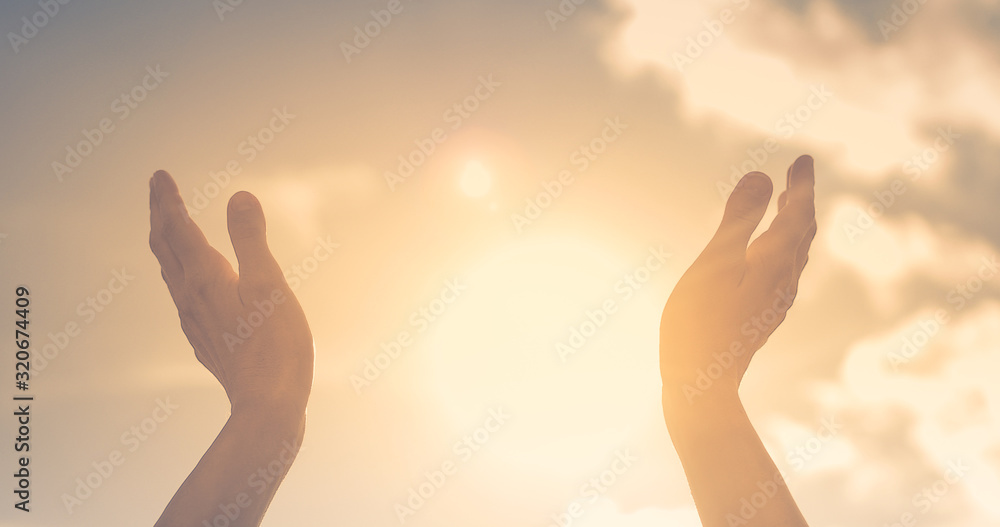 Female lifting hands up to sunset sky. Happiness, salvation and feeling ...