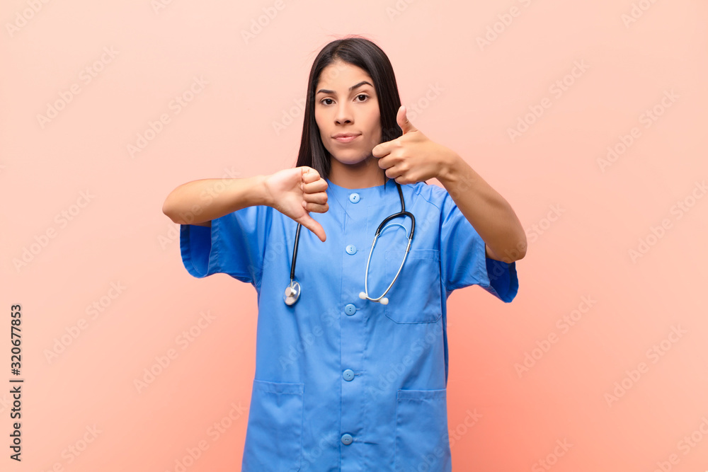 young latin nurse feeling confused, clueless and unsure, weighting the ...
