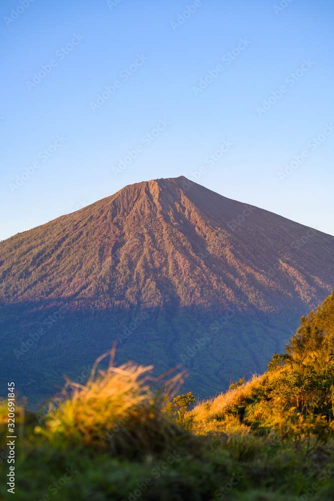 (Selective focus) Stunning view of the Mount Rinjani illuminated by a ...