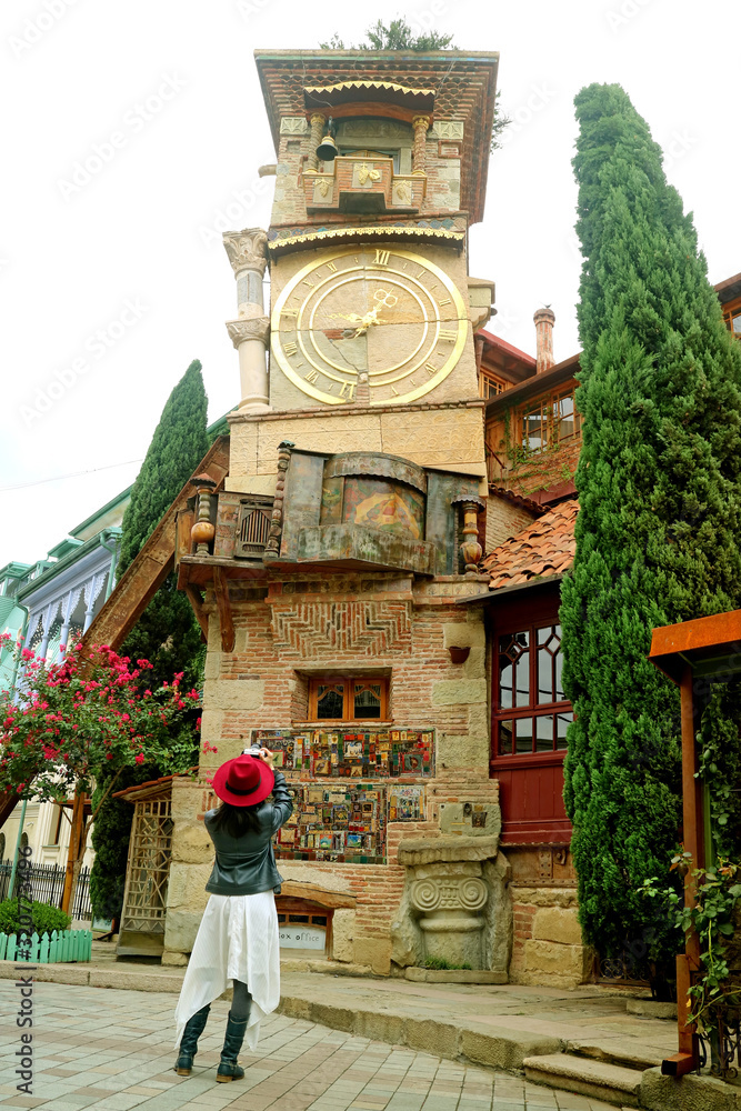 Female Traveler Taking Photos of the Leaning Clock Tower Created by the ...