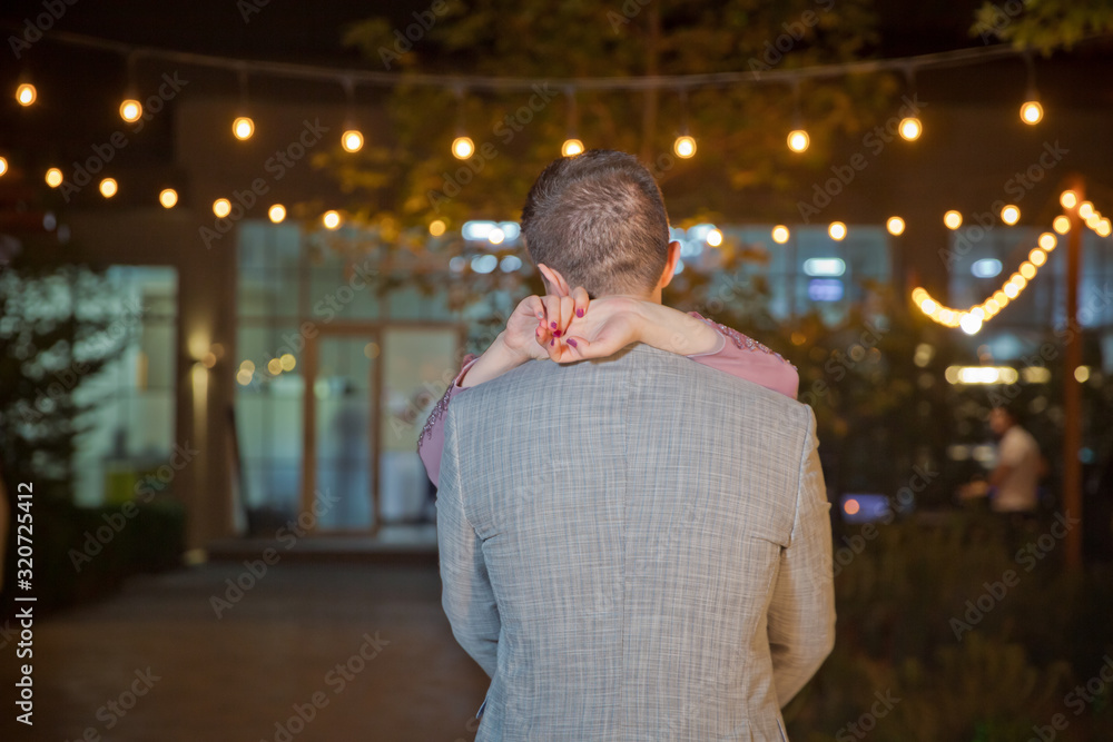 He is with back toward the camera, she stares at the camera blurred ...