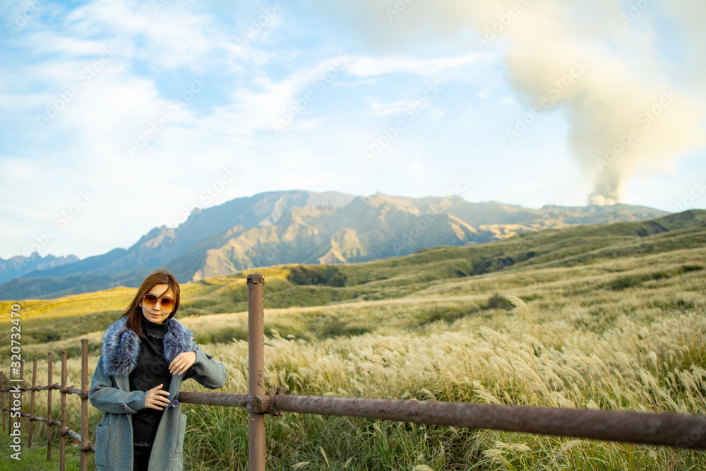 Lonely girl in Area of Aso active volcano background with smoke at ...