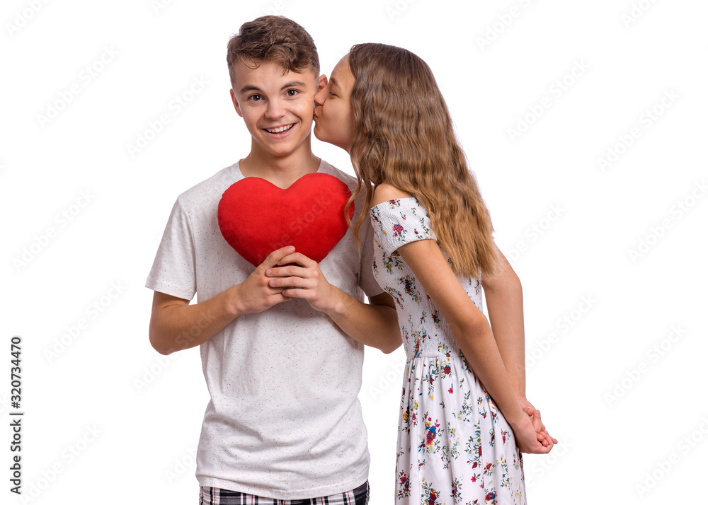 Portrait of sweet young teenagers couple in love - first kiss. Teen boy ...