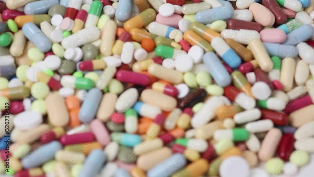 Closeup shot focusing in and out of pills in a pile rotating Stock ...
