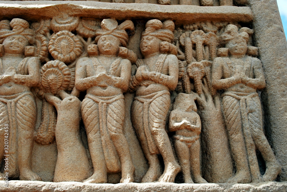 Carved details depicting the Stupa Puja, that includes birds, animals ...