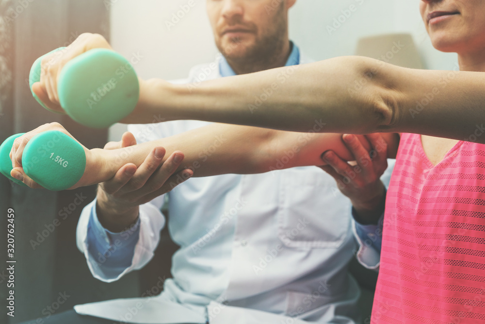 physiotherapy - physiotherapist help woman patient to recover from hand ...