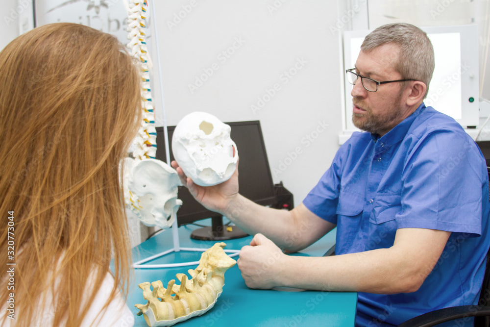 The doctor osteopath and chiropractor in the hospital explains to the ...