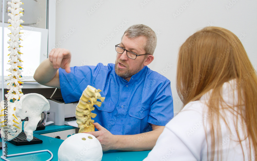 The doctor osteopath and chiropractor in the hospital explains to the ...