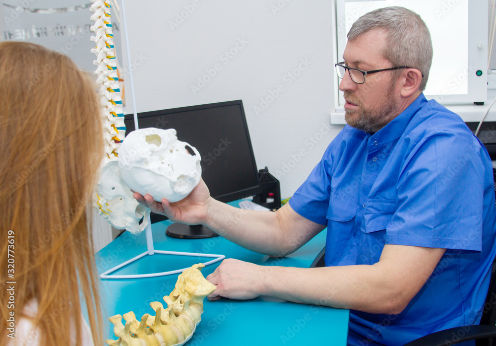 The doctor osteopath and chiropractor in the hospital explains to the ...