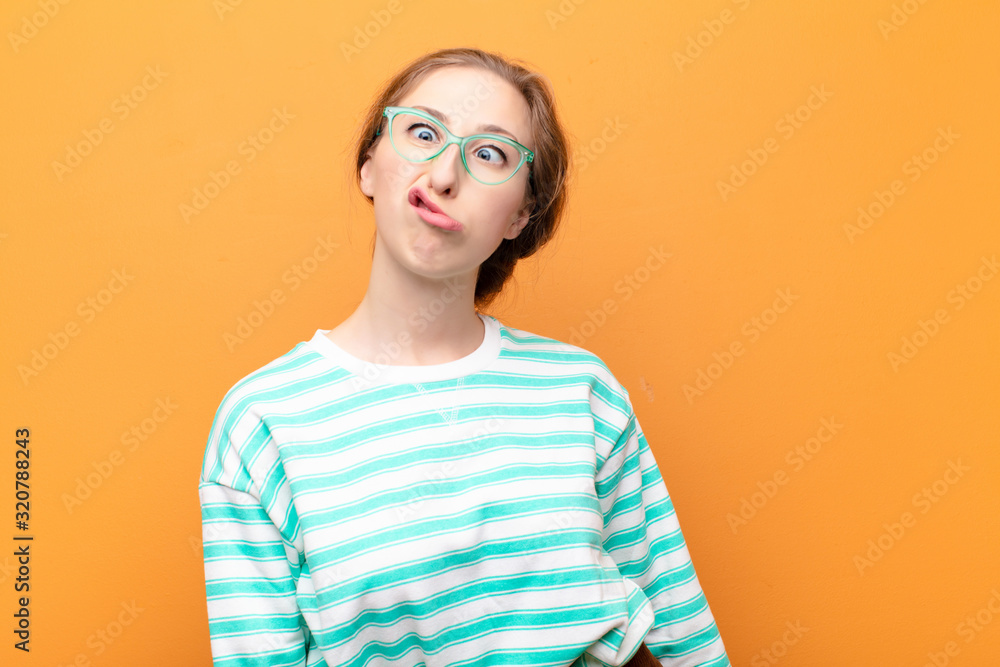 yound blonde woman looking goofy and funny with a silly cross-eyed ...