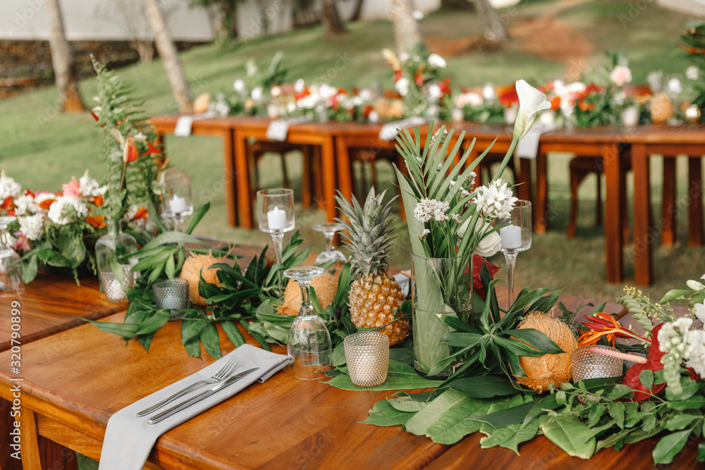 table appointments with beautiful decor - tropical flowers, pineapple ...