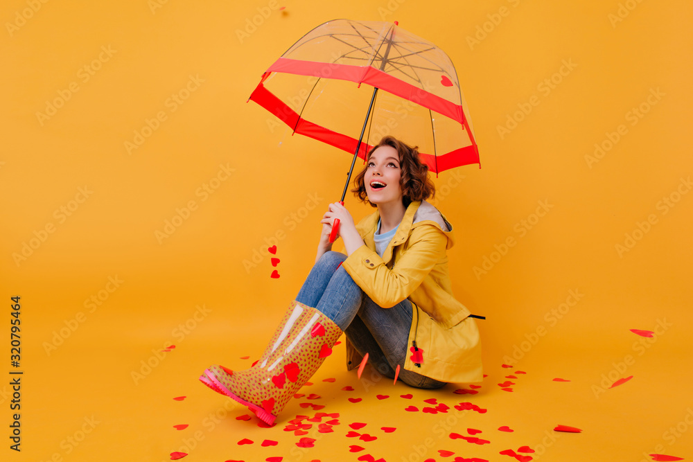 Gorgeous short-haired girl with beautiful eyes posing under parasol ...