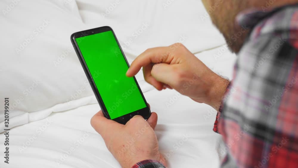 A Man Uses A Green Screen On The Phone. Hand Holding A Mobile Phone ...