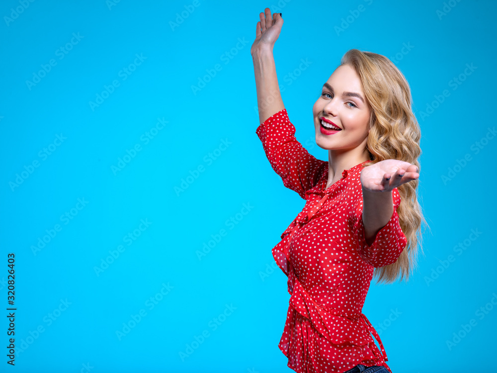 Young happy blonde woman with raised hands. Beautiful girl with raised ...