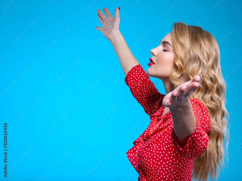 Young happy blonde woman with raised hands. Beautiful girl with raised ...
