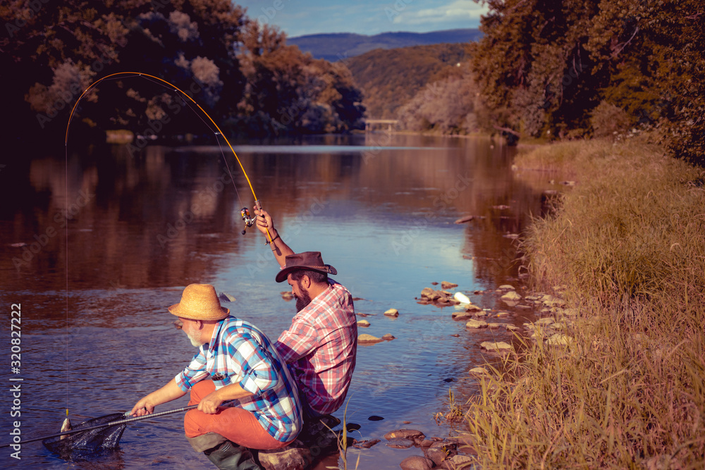 Portrait of cheerful two men fishing. Fly fishing. Perfect weekend ...