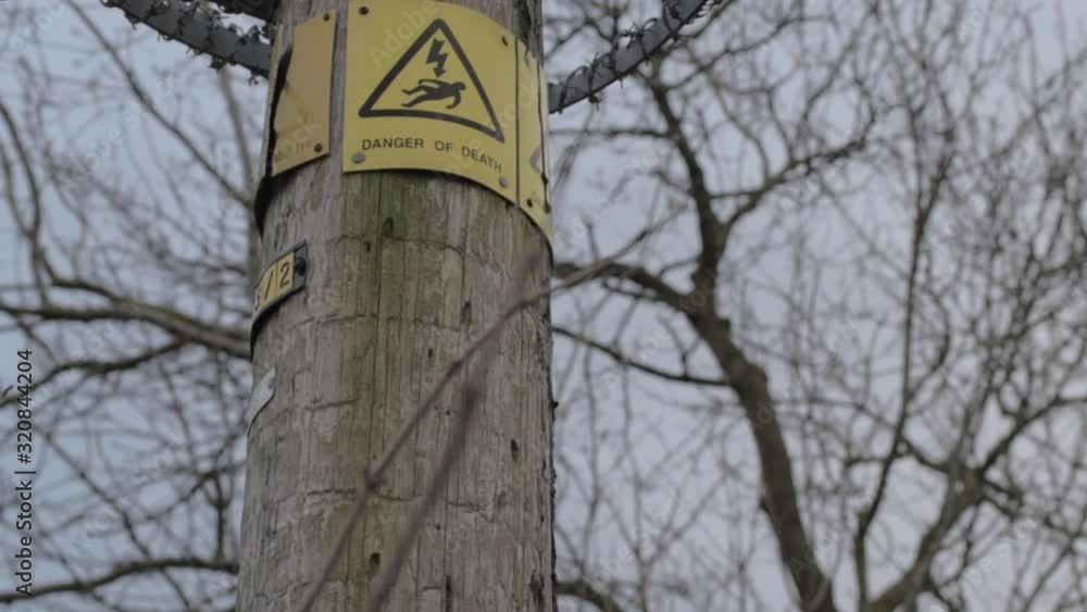 Electricity power pylon pole and cables with danger of death sign ...