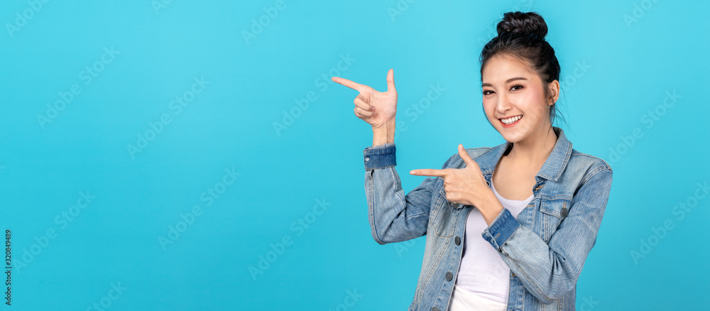 Banner of Happy asian woman standing pointing hands to copyspace on ...