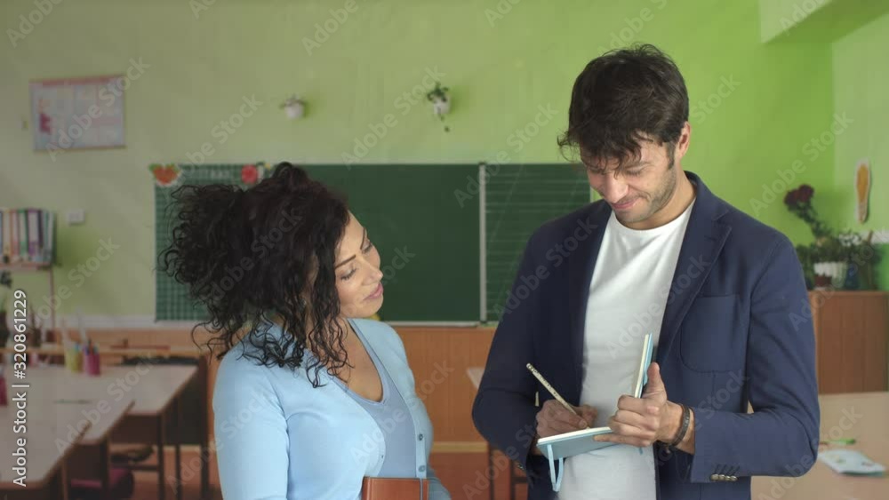 Portrait of confident young schoolteachers working together in a ...