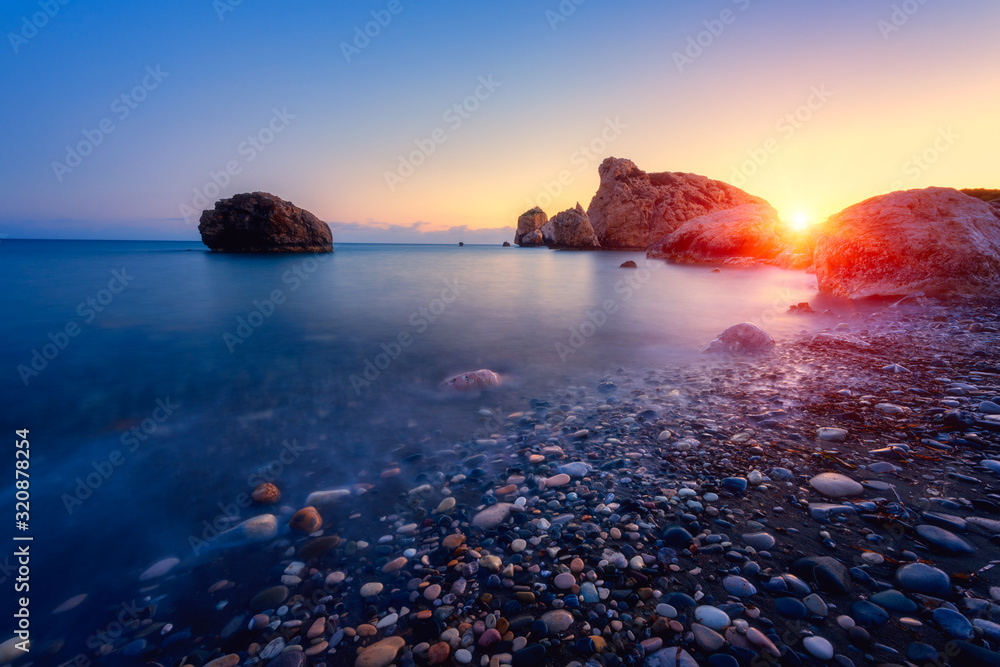 Amazing sunset seascape, famous Love beach on Cyprus with rocks and sea ...