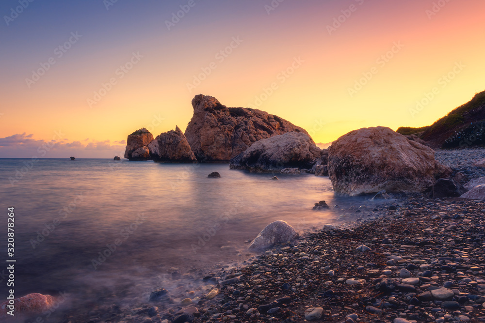 Amazing sunset seascape, famous Love beach on Cyprus with rocks and sea ...